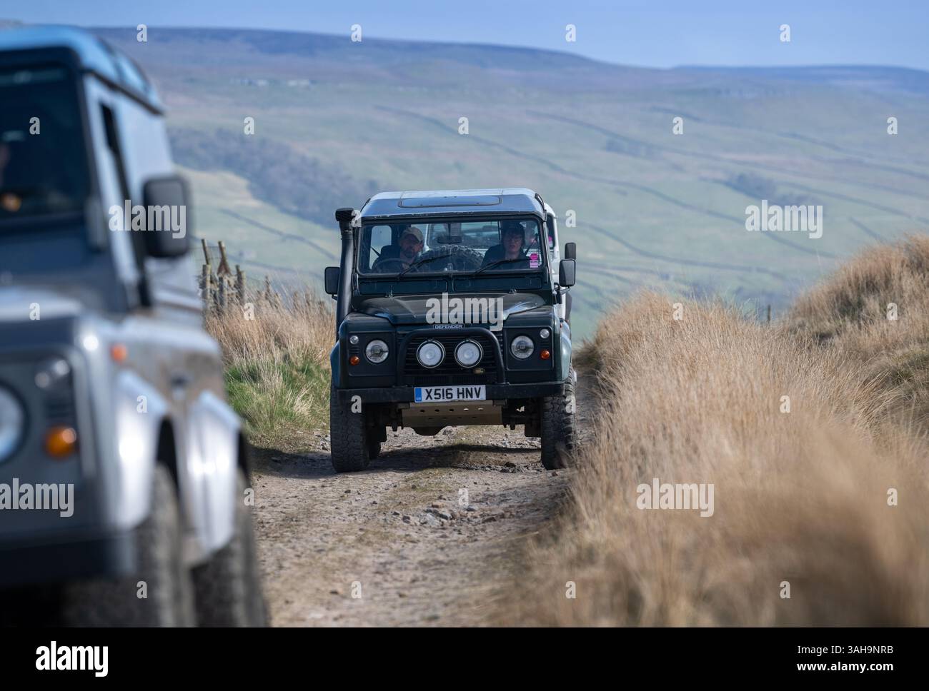 Land Rover Defenders travelling down some rough Green Lanes in the ...