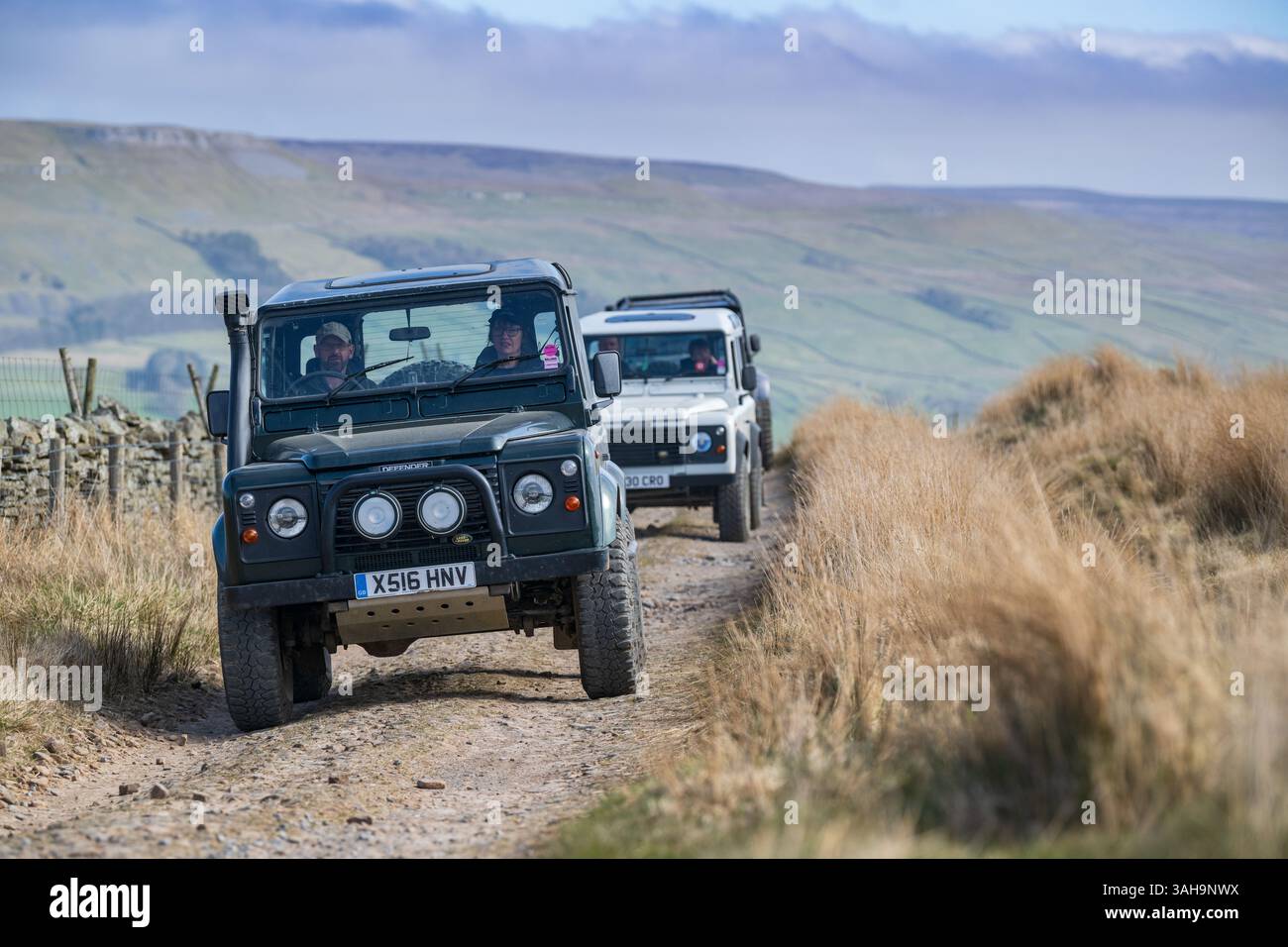 Land Rover Defenders travelling down some rough Green Lanes in the ...
