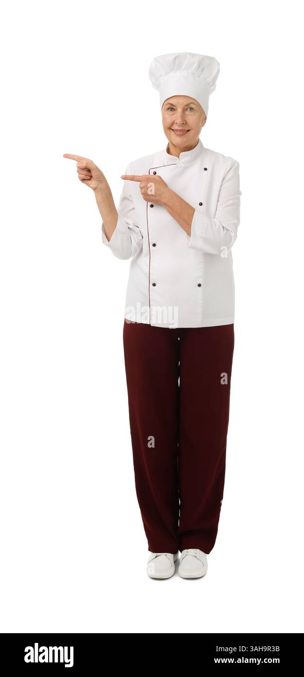 Professional pastry chef pointing at something on white background ...