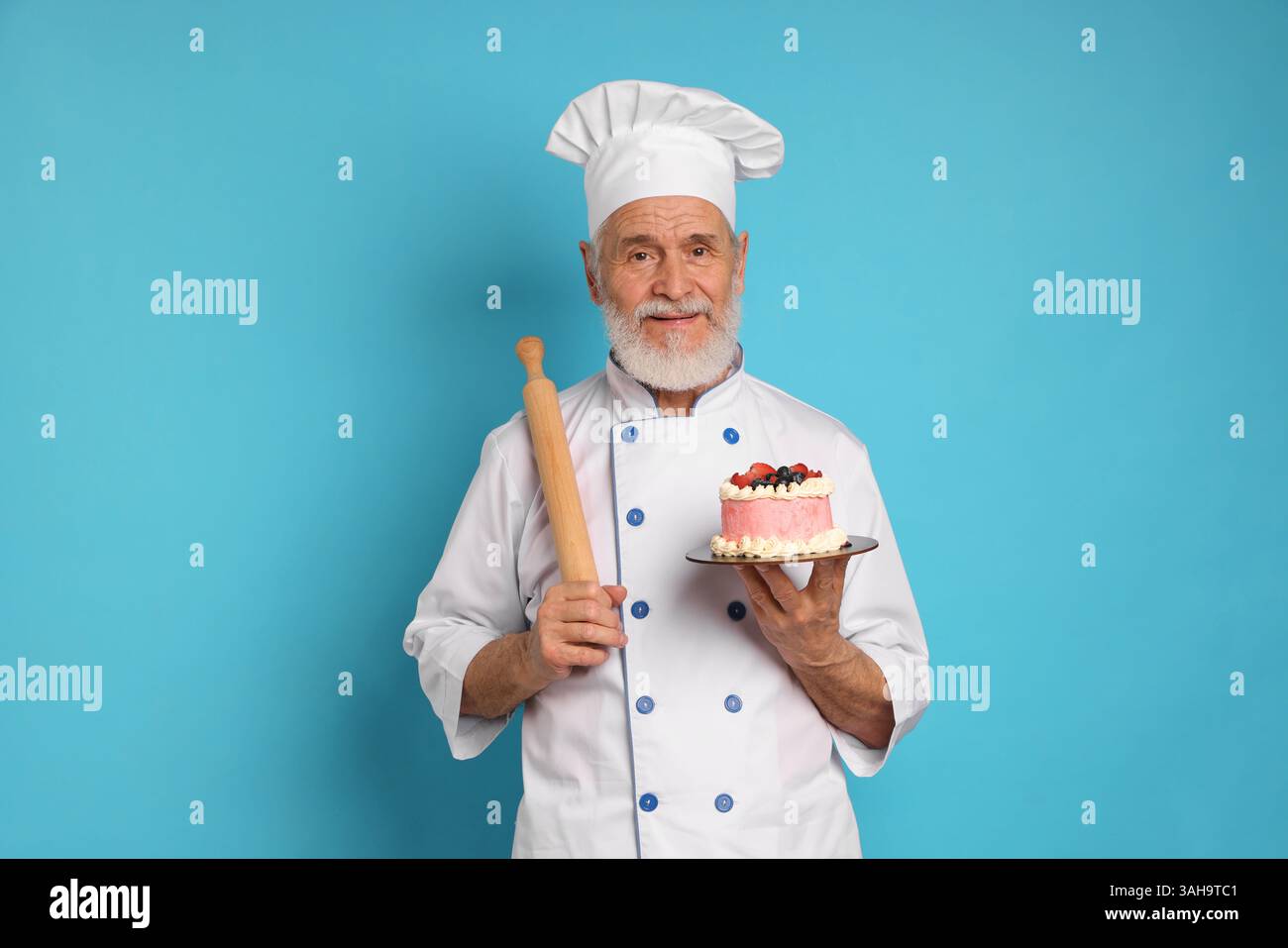 Professional pastry chef with delicious cake and rolling pink on light ...