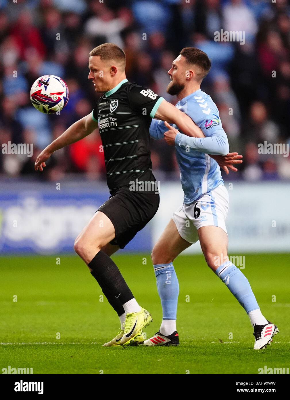 Portsmouth's Colby Bishop (left) and Coventry City's Matt Grimes battle ...