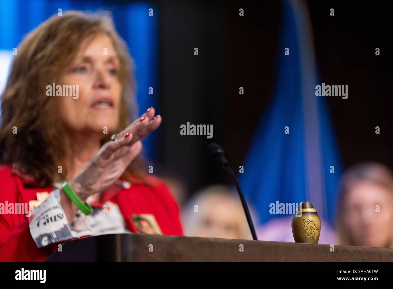 Sabine Durden-Coulter speaks about the death of her son, with an urn of ...