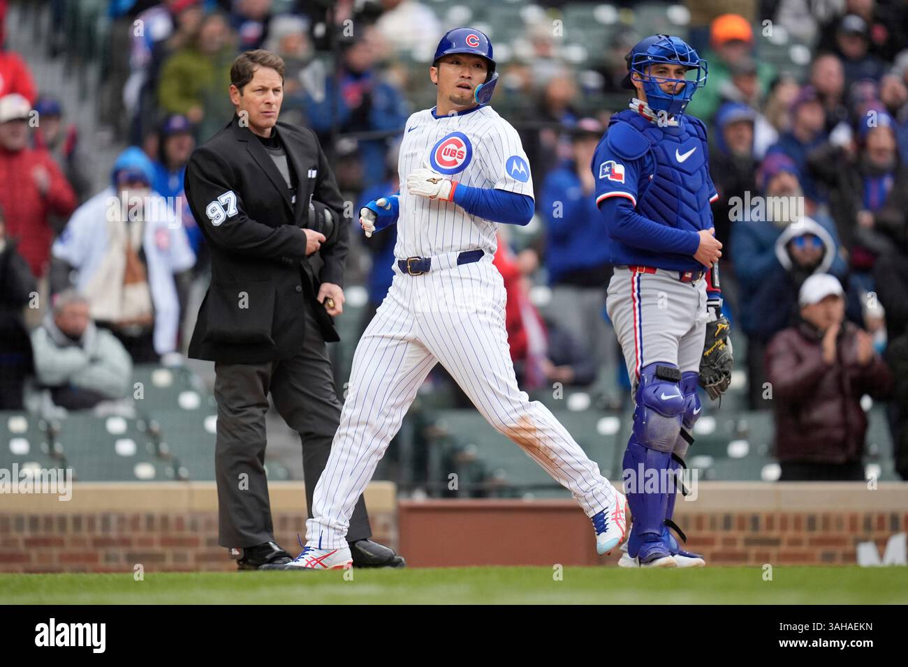 Chicago Cubs designated hitter Seiya Suzuki (27) scores on a single by ...