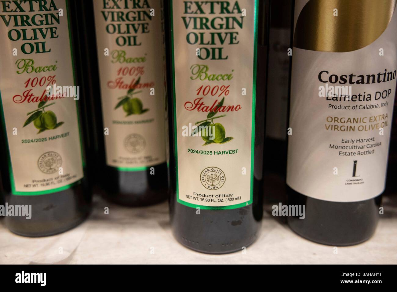 Bottles of olive oil produced in Italy are displayed at Italian grocery ...