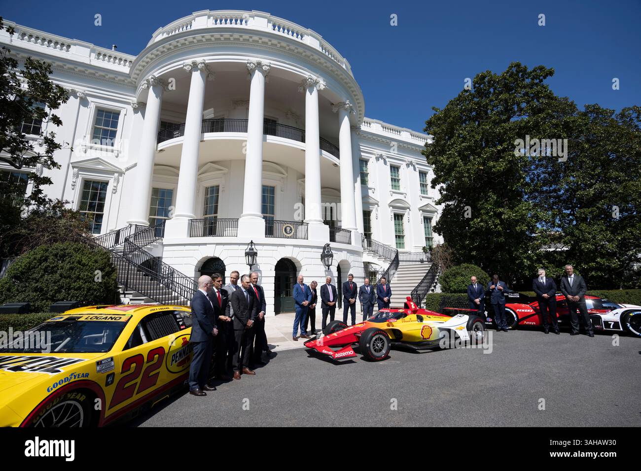Race cars owned by Roger Penske are lined up on the driveway of the ...