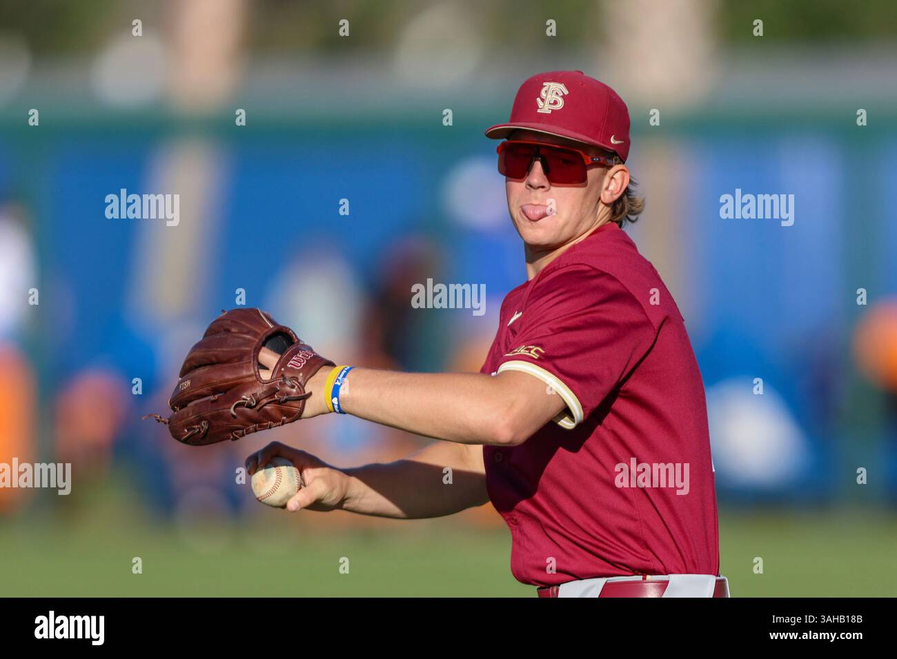 Florida State infielder Cal Fisher (4) warms up before an NCAA baseball ...