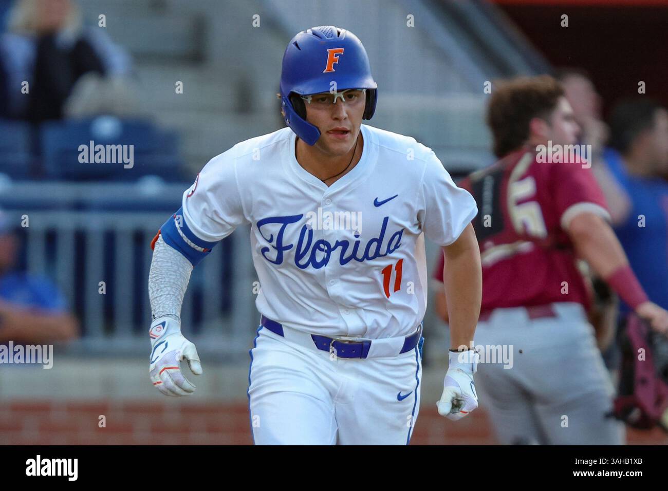 Florida infielder Brendan Lawson (11) runs to first base during an NCAA ...