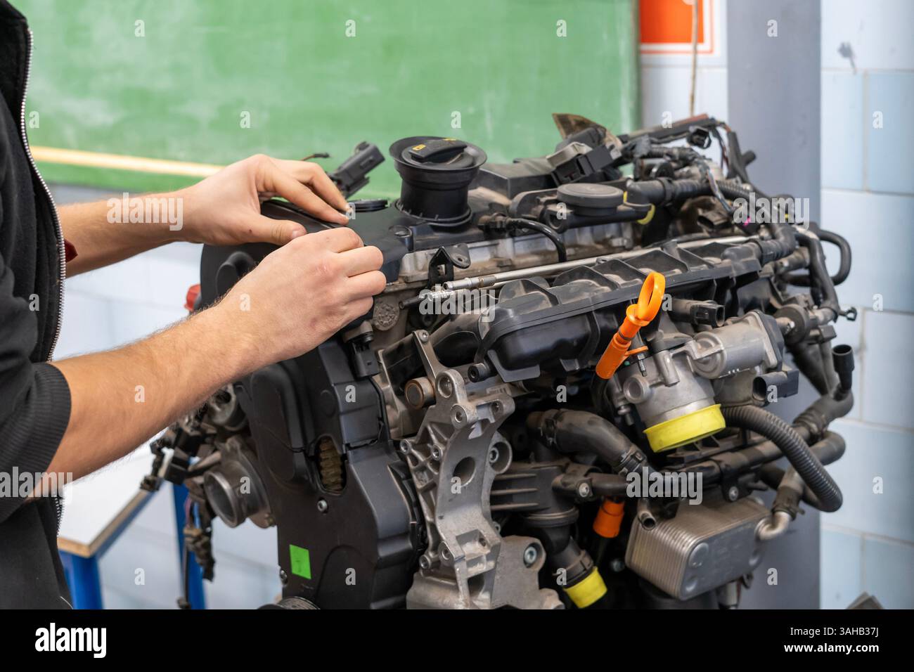 Car mechanic repairing a car engine in a car repair shop Stock Photo ...