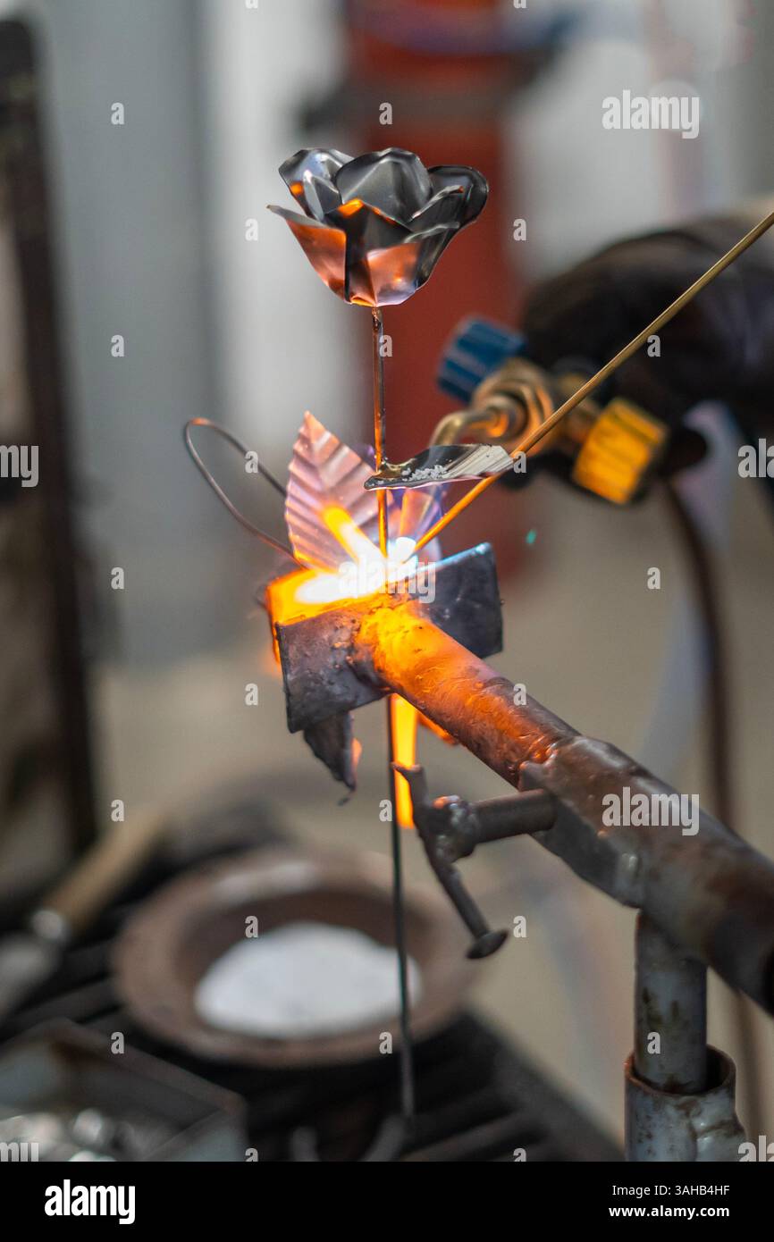 A craftsman welding a metal rose Stock Photo - Alamy