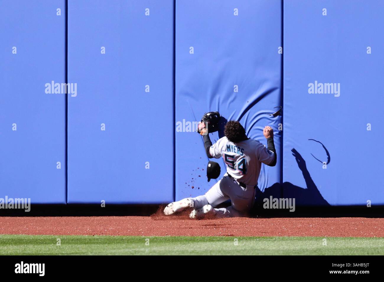 Miami Marlins' outfielder Dane Myers hits the wall after catching a ...