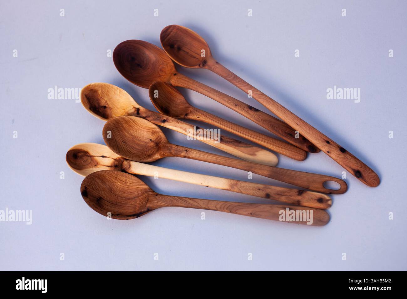 Wooden kitchen utensils stacked view isolated Stock Photo - Alamy