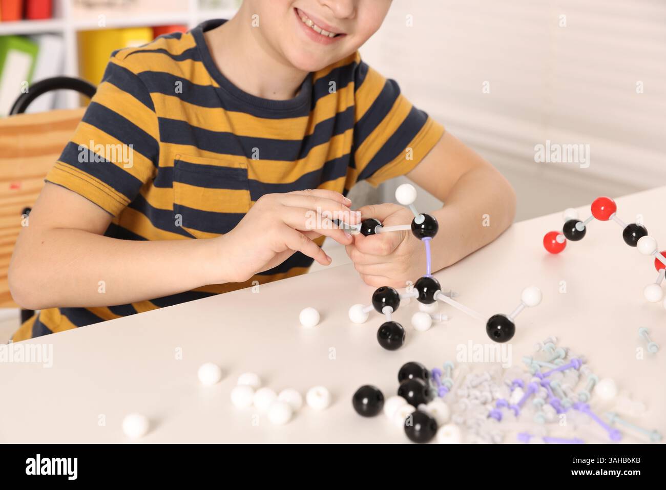 Boy making DNA structure model at desk indoors, closeup Stock Photo - Alamy
