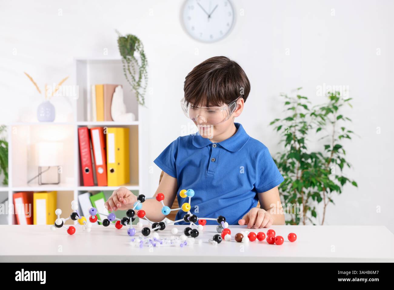 Boy making DNA structure model at desk indoors Stock Photo - Alamy