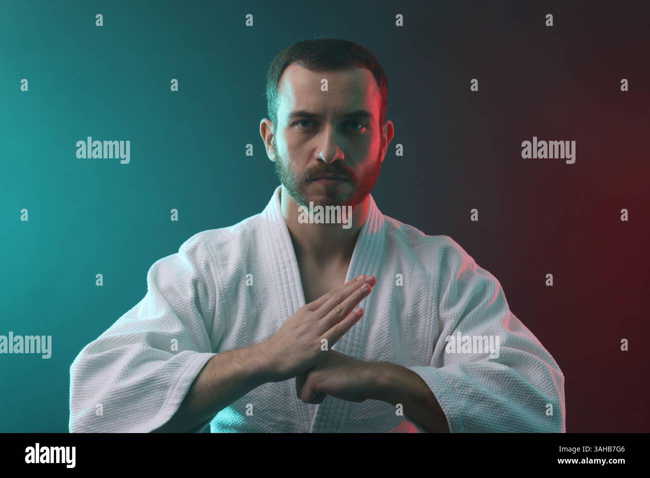 Karate fighter wearing uniform in color lights Stock Photo - Alamy