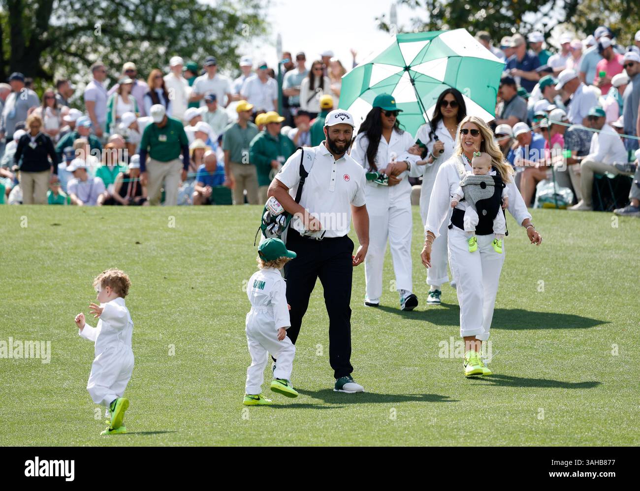 Jon Rahm of Spain walks with his wife Kelley Cahill and their children ...