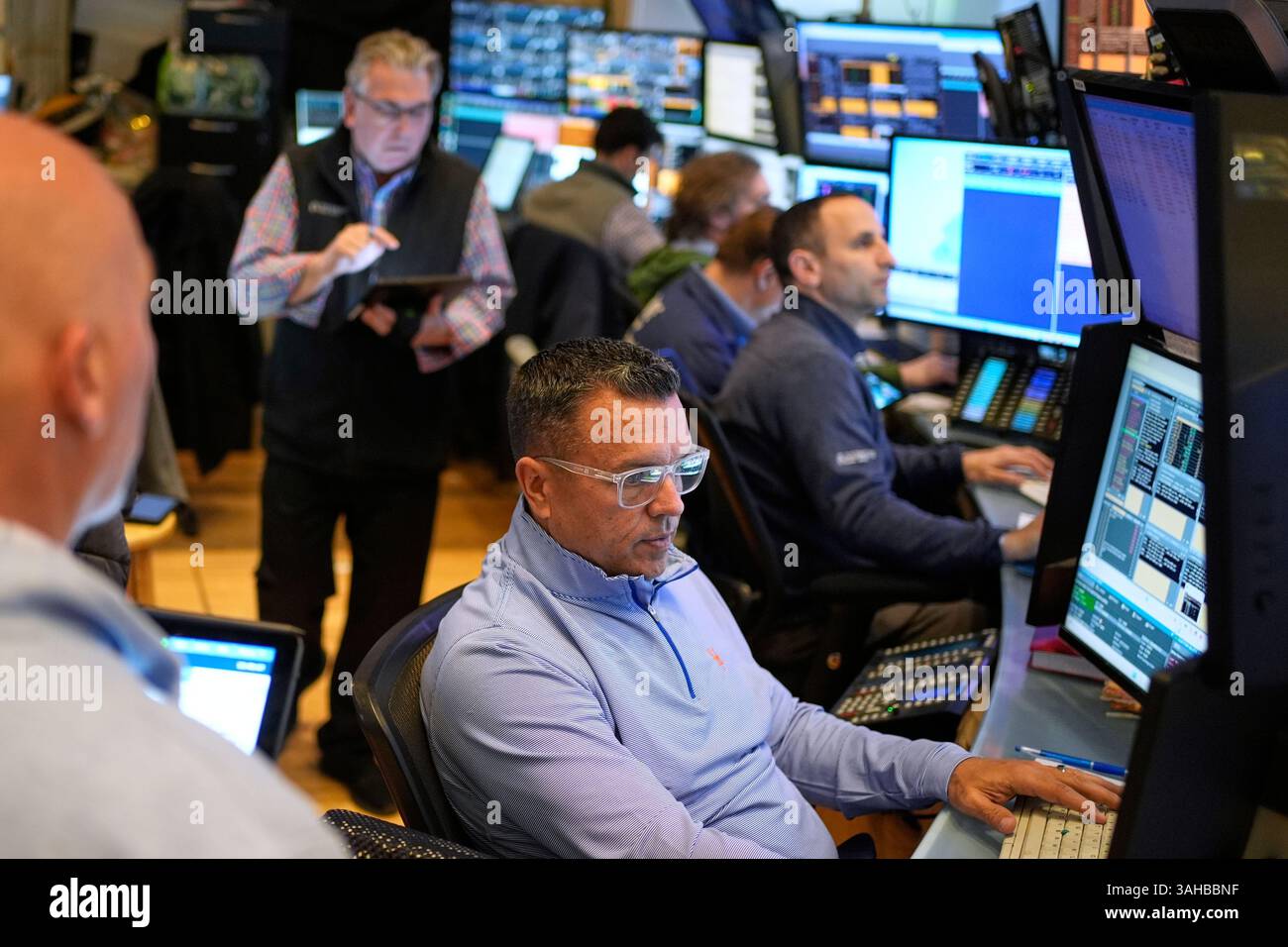 Traders work on the floor at the New York Stock Exchange in New York ...