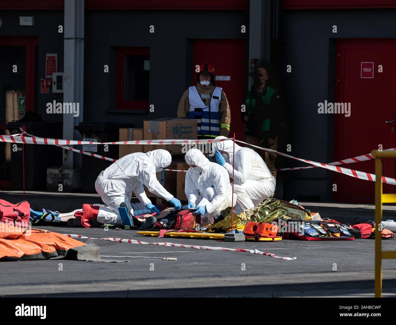 Medical personnel dressed in anti-contamination costume help victims as ...