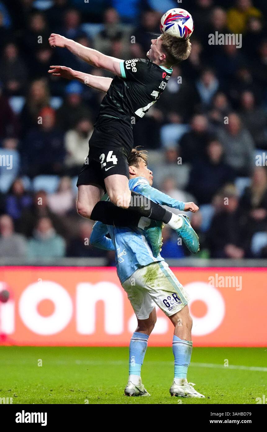 Portsmouth's Terry Devlin rises high to head the ball away from ...