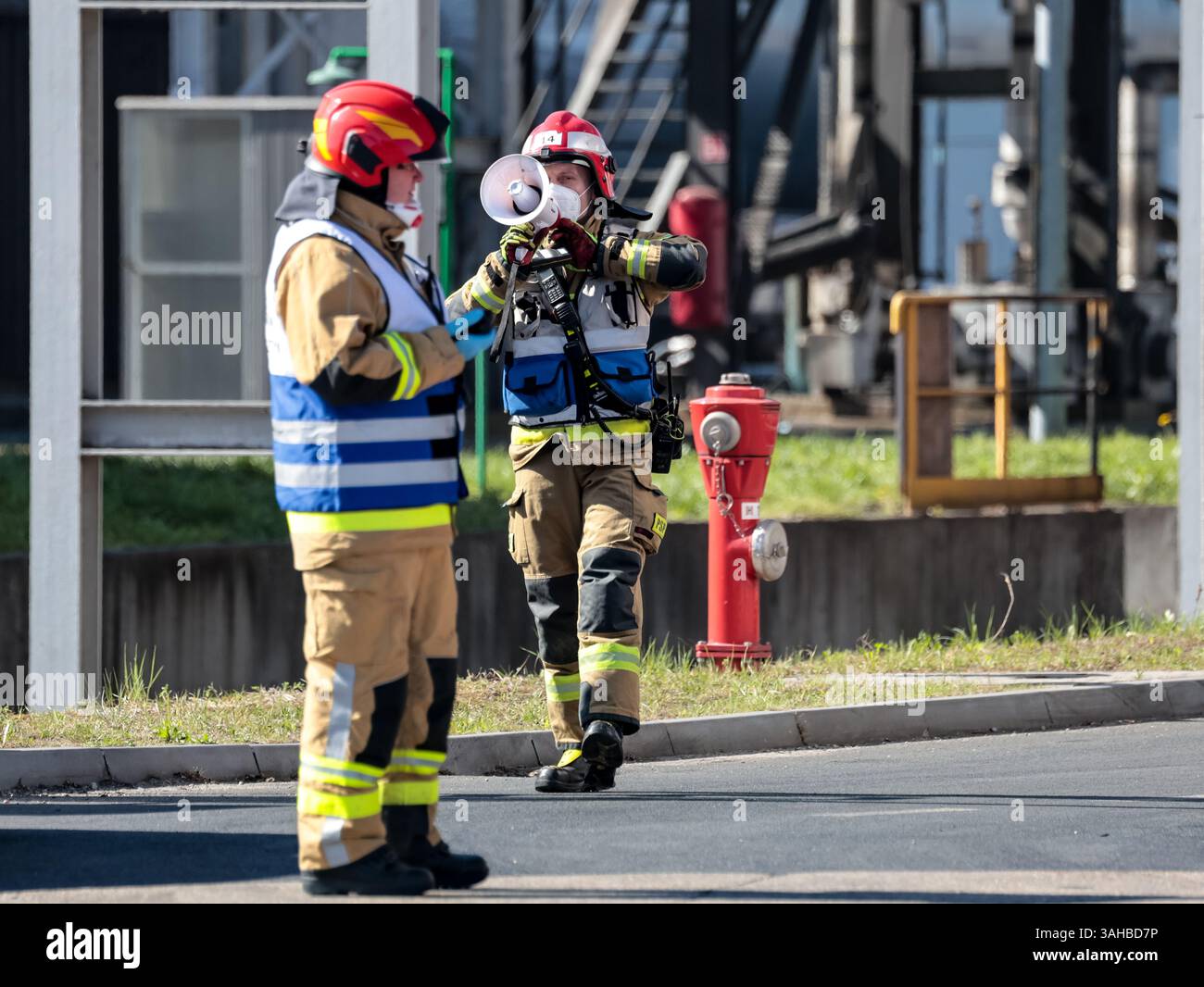 Fire-fighters dressed in anti-contamination costumes safeguard a ...