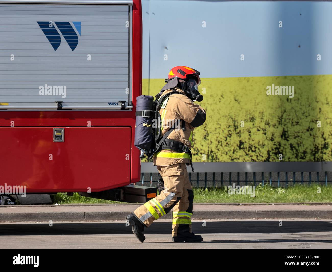 Fire-fighter dressed in anti-contamination costume safeguards a ...