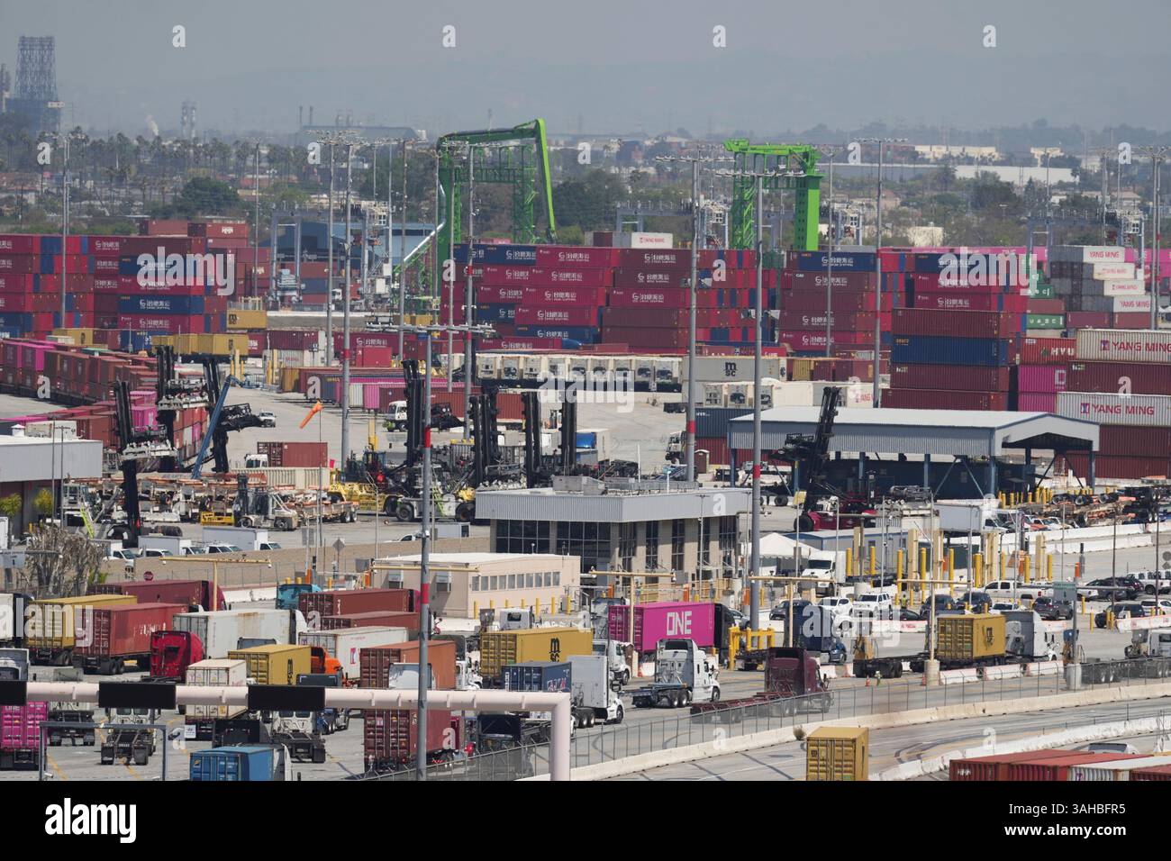 Inbound trucks line up to load shipping containers at the Port of Los ...
