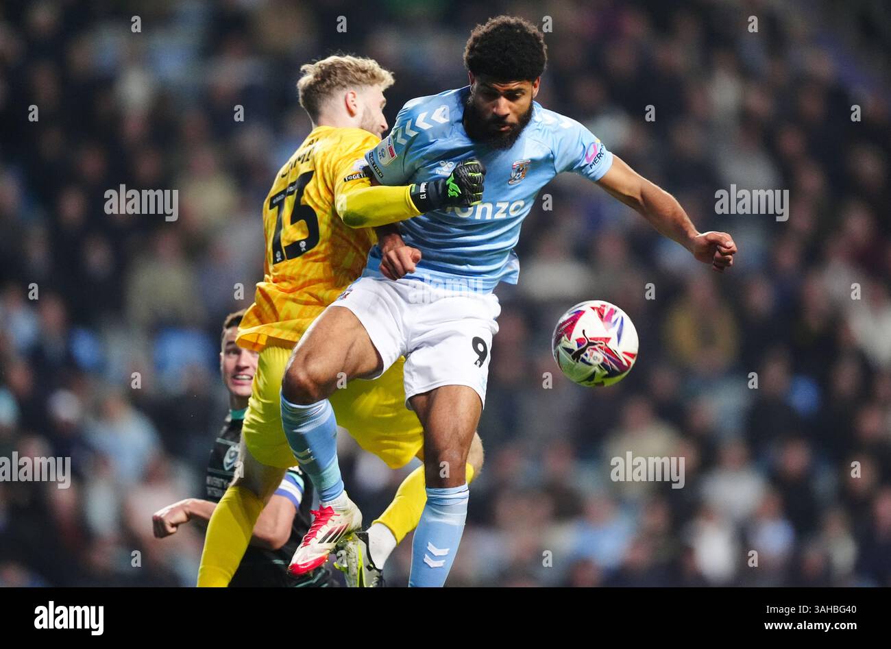 Coventry City's Ellis Simms (right) tries to win the ball ahead of ...