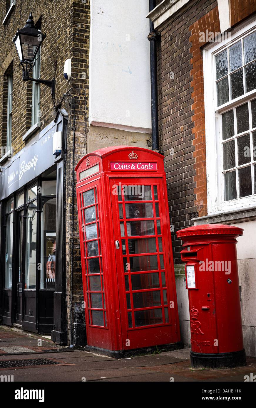 Iconic British red pillar post box next to a red telephone box which ...