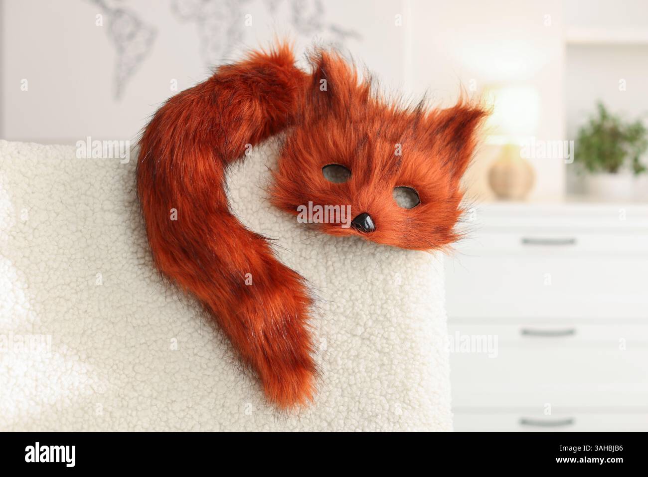 Quadrobics. Fox mask and tail on armchair indoors Stock Photo - Alamy