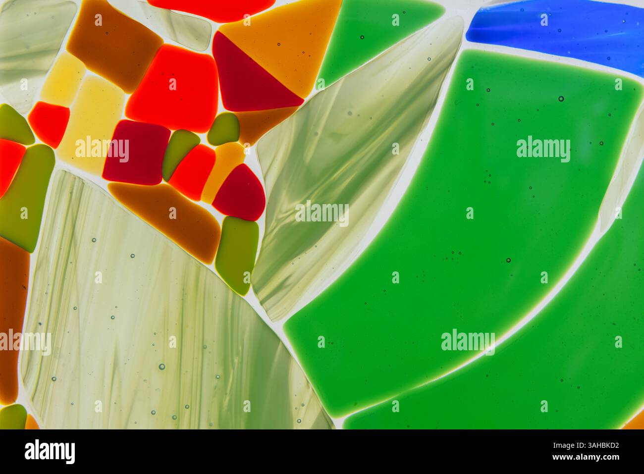 Colorful abstract stained glass featuring a blend of diferent colors ...