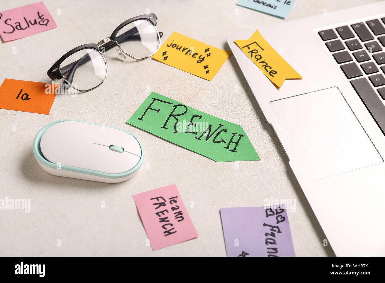 Composition with French words, modern laptop, computer mouse and ...