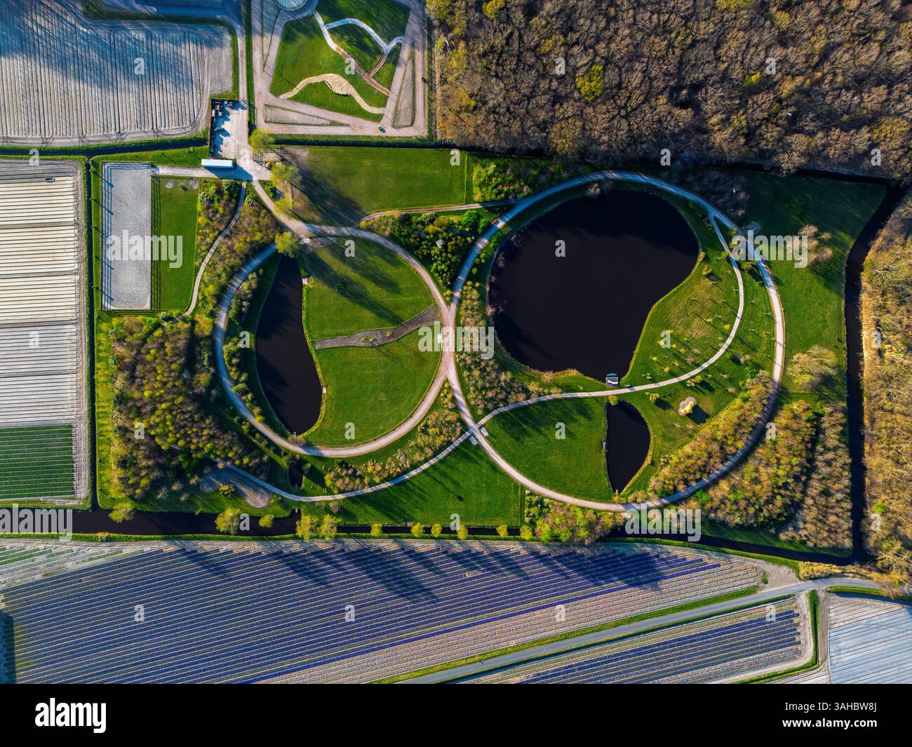 Aerial view of a uniquely designed park with circular paths and ponds ...