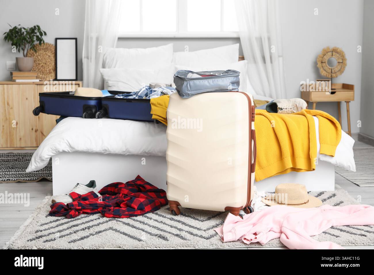 Suitcases with scattered clothes in messy bedroom Stock Photo - Alamy