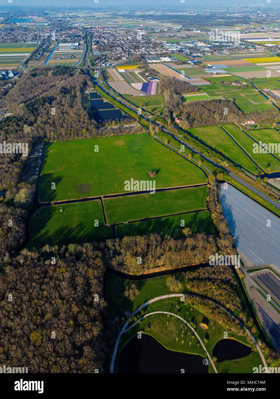 Aerial view of a rural landscape with green fields, forests, ponds, and ...