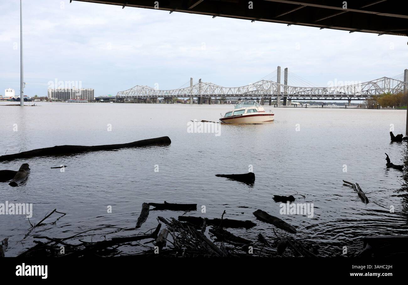A cabin cruiser and debris washes up along the Ohio River as flood ...