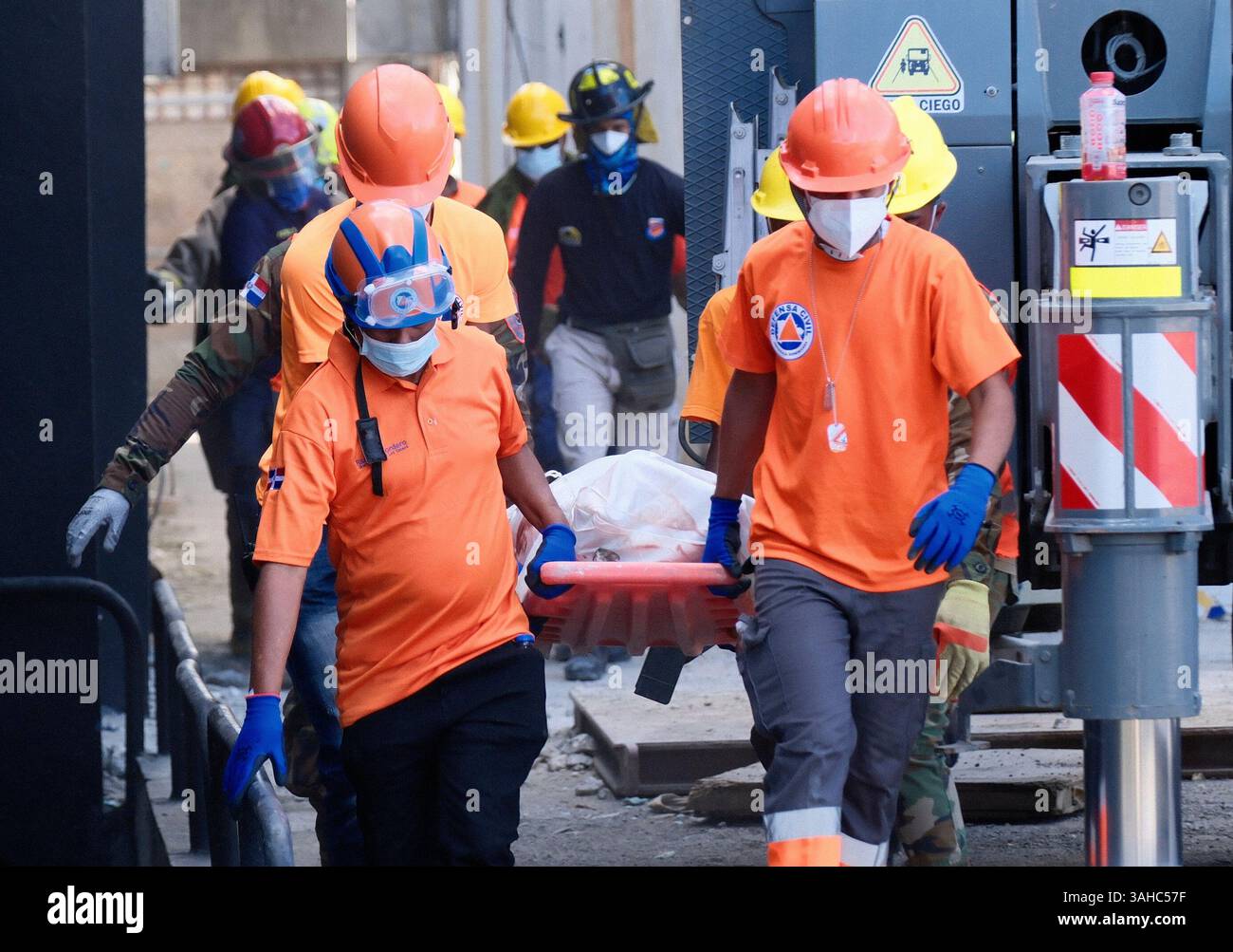 Rescue workers carry the recovered body of a victim who died when the ...