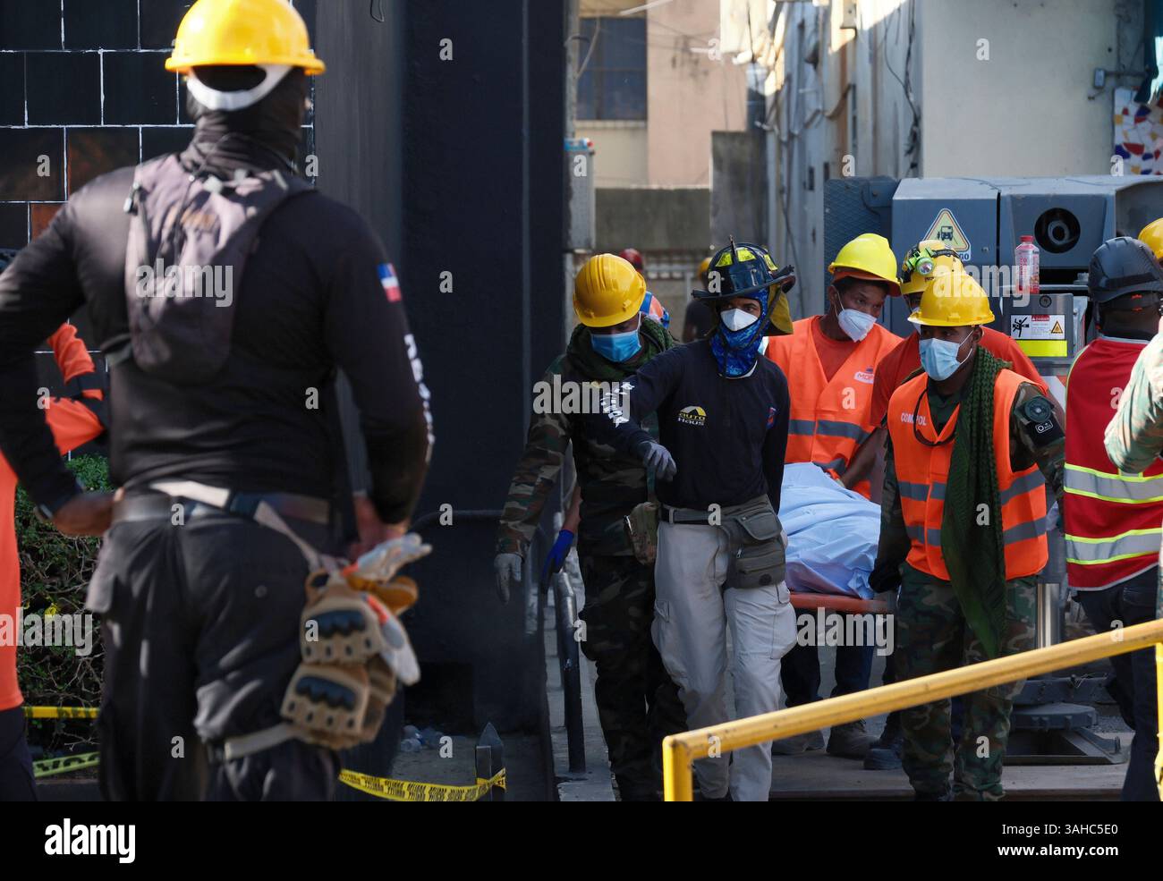 Rescue workers carry the recovered body of a victim who died when the ...