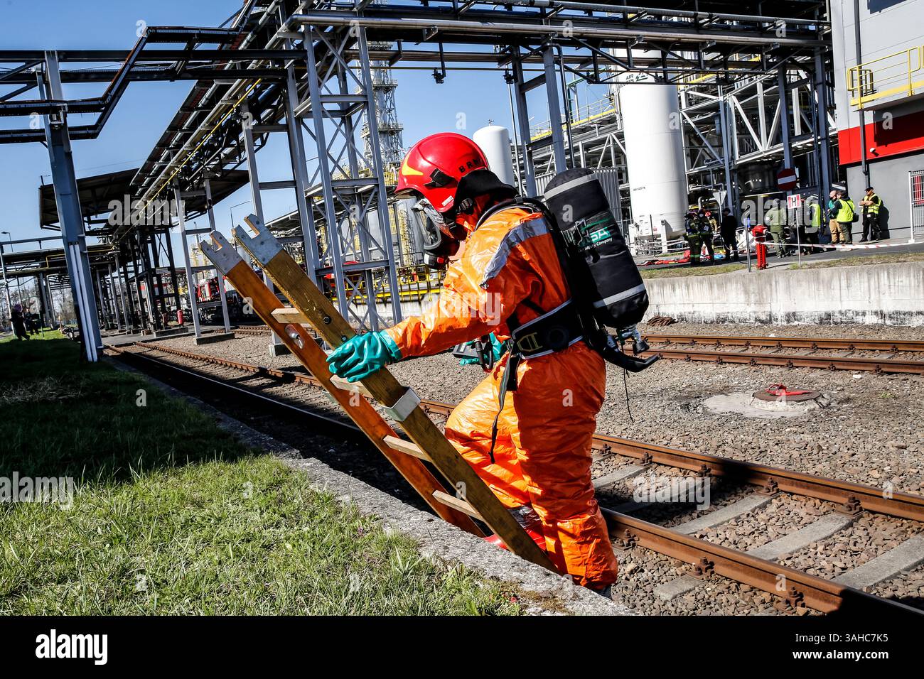 Fire-fighter dressed in an anti-contamination costume safeguards a ...
