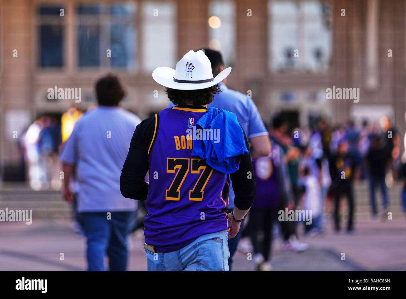 Madison Perrin of Dallas wears a Los Angeles Lakers' Luka Doncic jersey ...