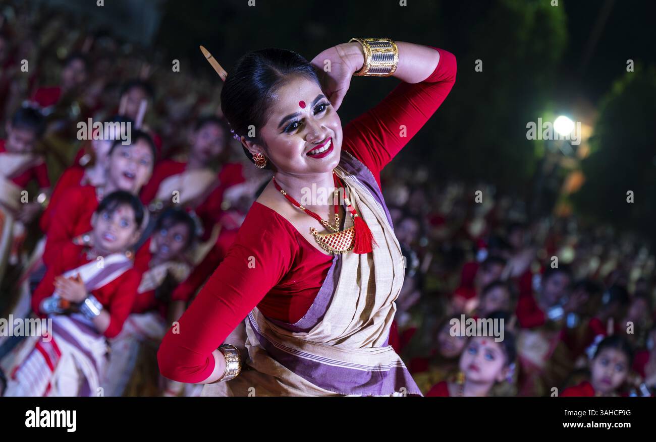 An instructor dance as participants follows the dance step in a Bihu ...