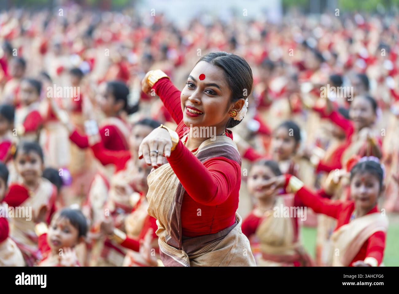 An instructor dance as participants follows the dance step in a Bihu ...