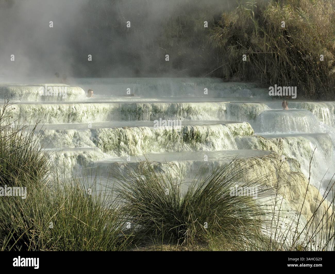 Warm sulphurous thermal springs, travertine waterfalls with clouds of ...