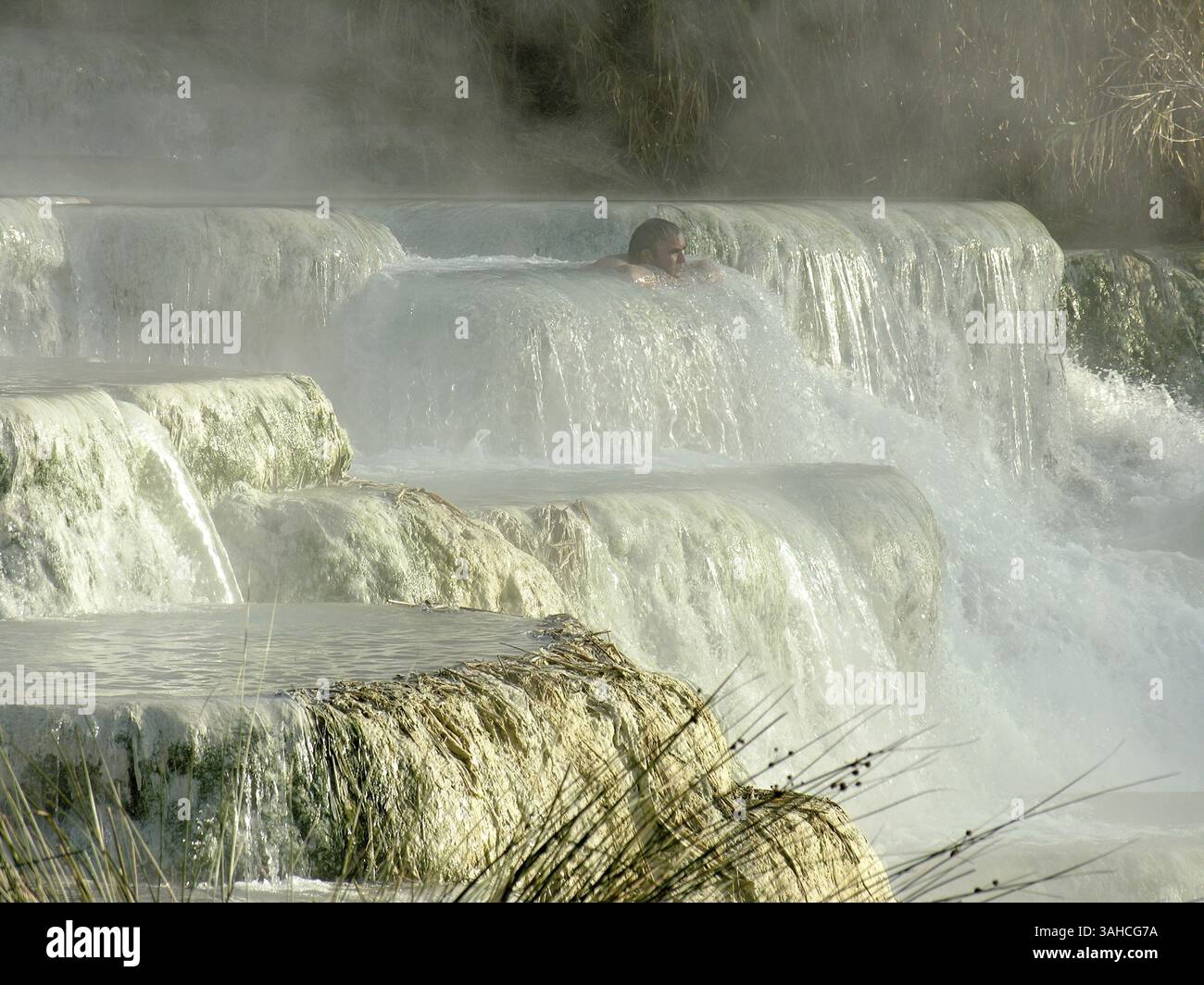 Warm sulphurous thermal springs, travertine waterfalls with clouds of ...