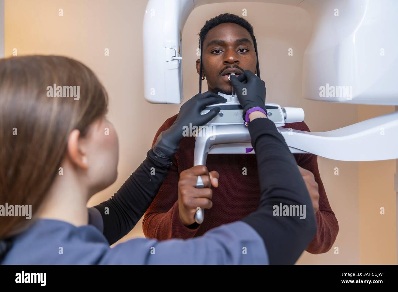 Dental professional preparing a patient for an x ray scan, ensuring ...