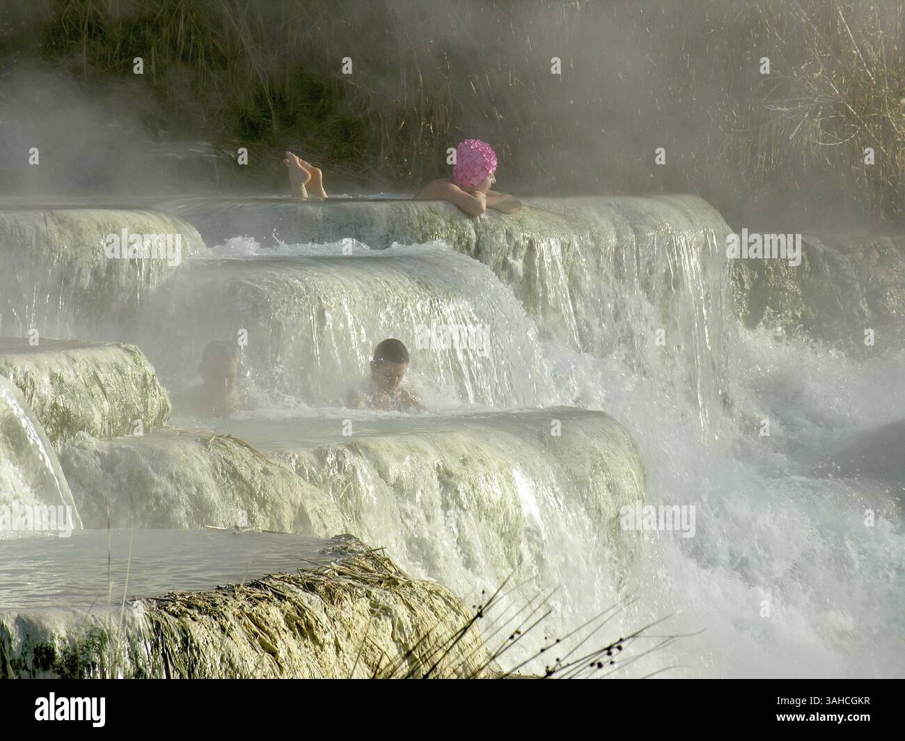 Warm sulphurous thermal springs, travertine waterfalls with clouds of ...