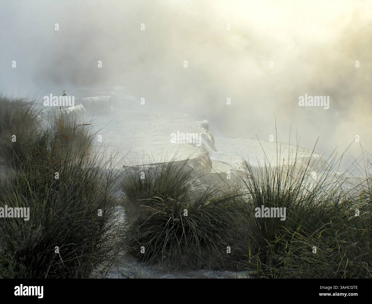 Warm sulphurous thermal springs, travertine waterfalls with clouds of ...