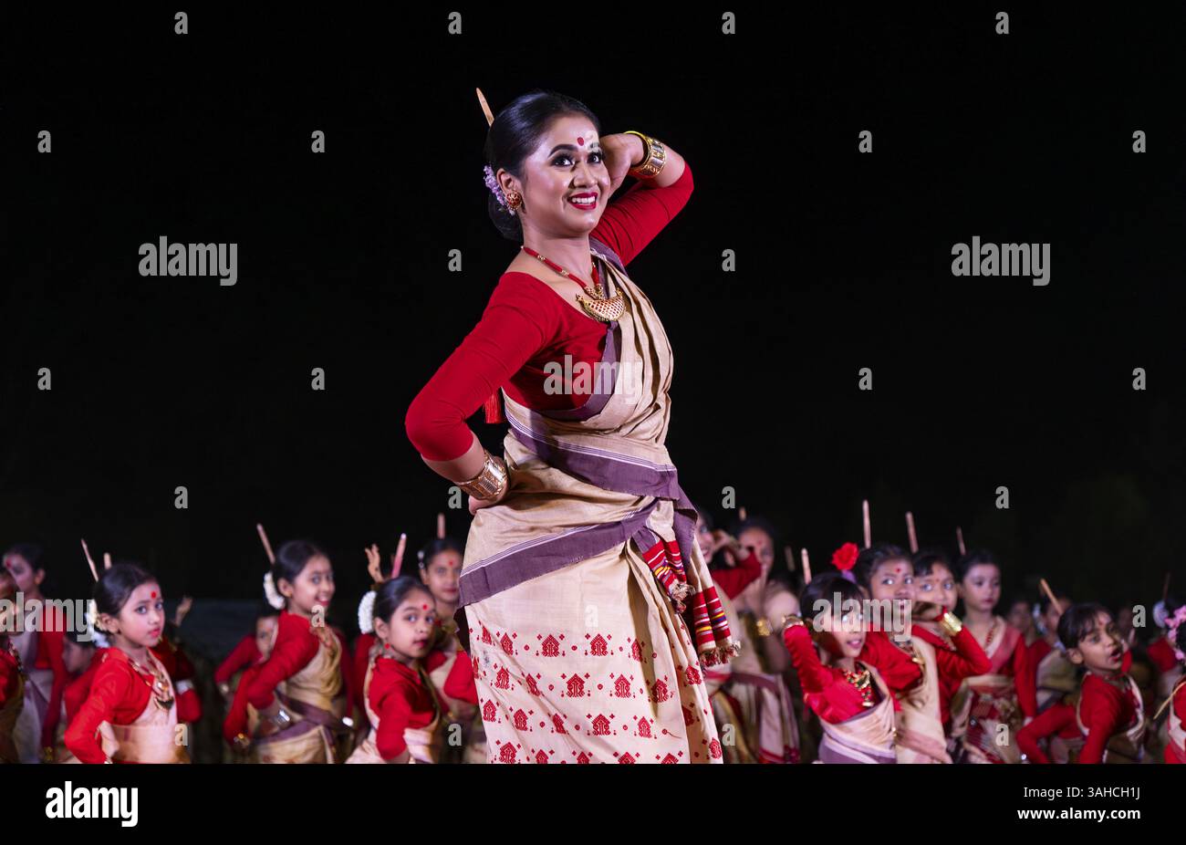 An instructor dance as participants follows the dance step in a Bihu ...