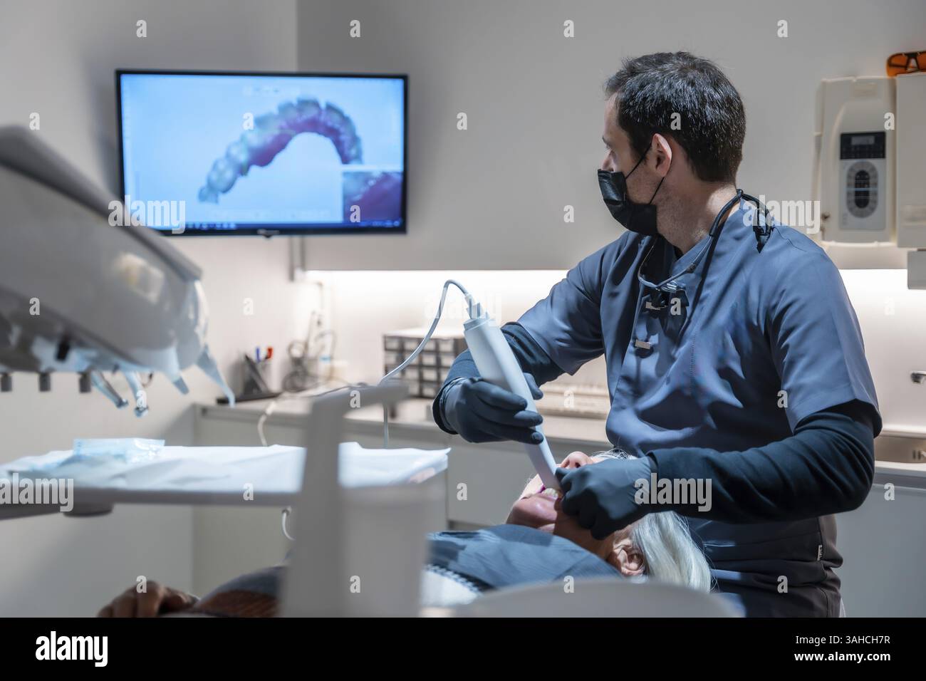 Dentist using an intraoral scanner for 3d scanning of teeth, creating ...