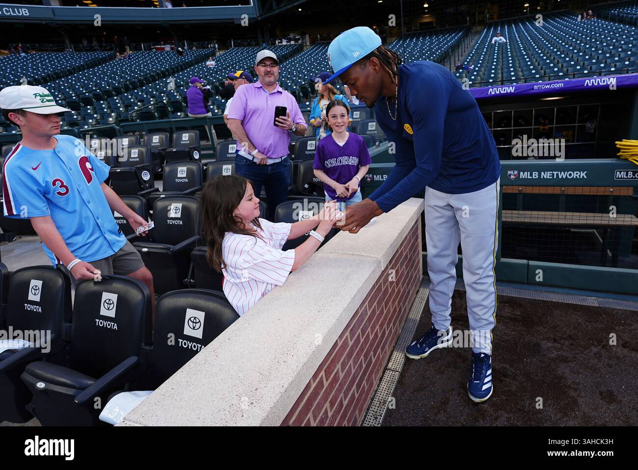 Milwaukee Brewers outfielder Jackson Chourio, right, signs an autograph ...