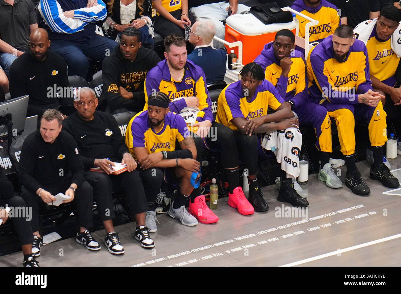 Los Angeles Lakers' Luka Doncic, wearing red shoes, sits on the bench ...