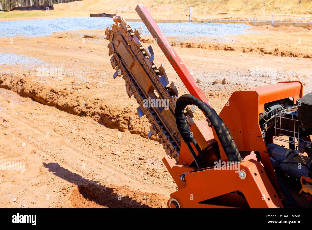 Construction equipment is actively trenching ground operator using ...